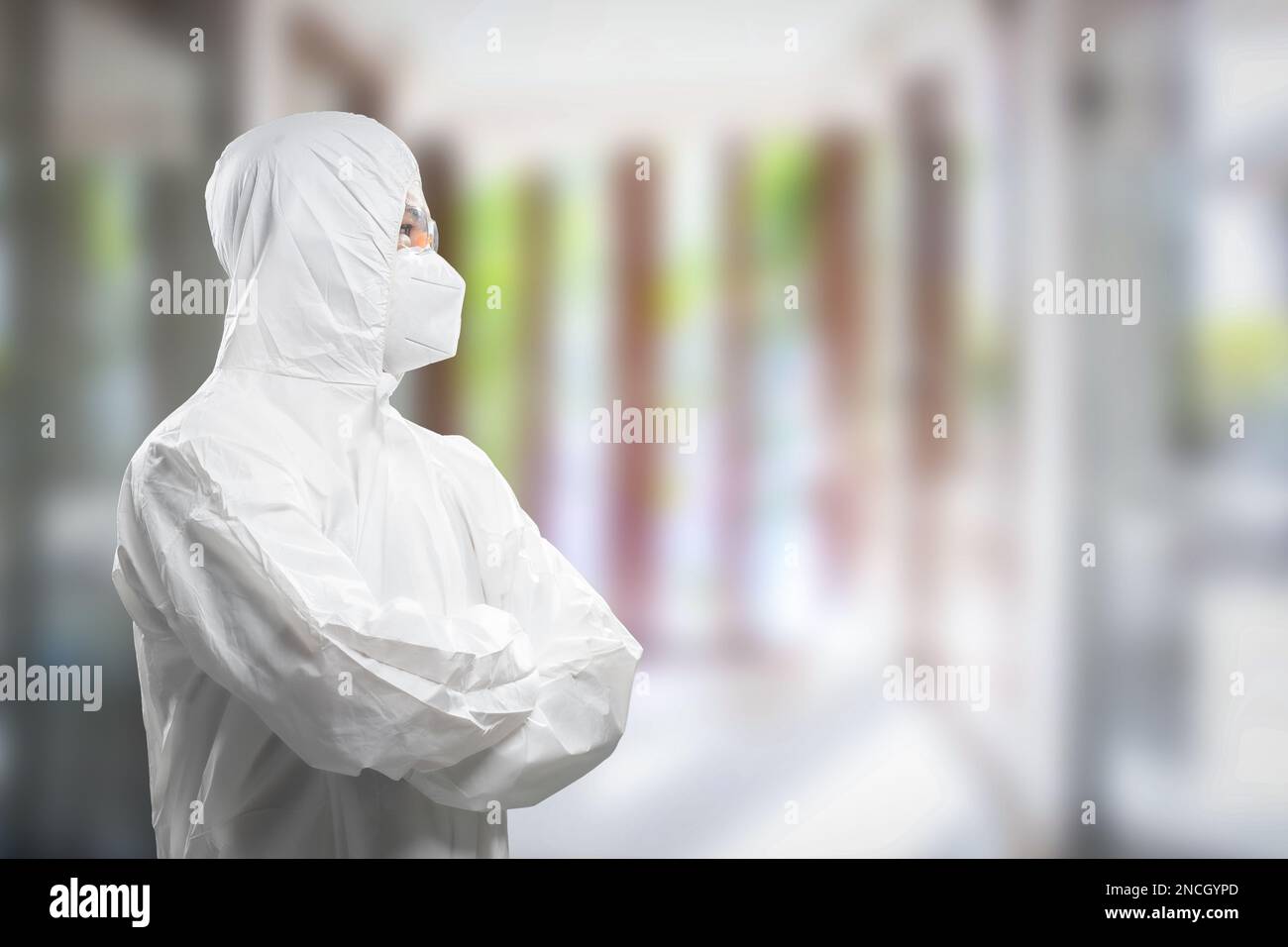 Worker wears medical protective suit or white coverall suit with mask ...