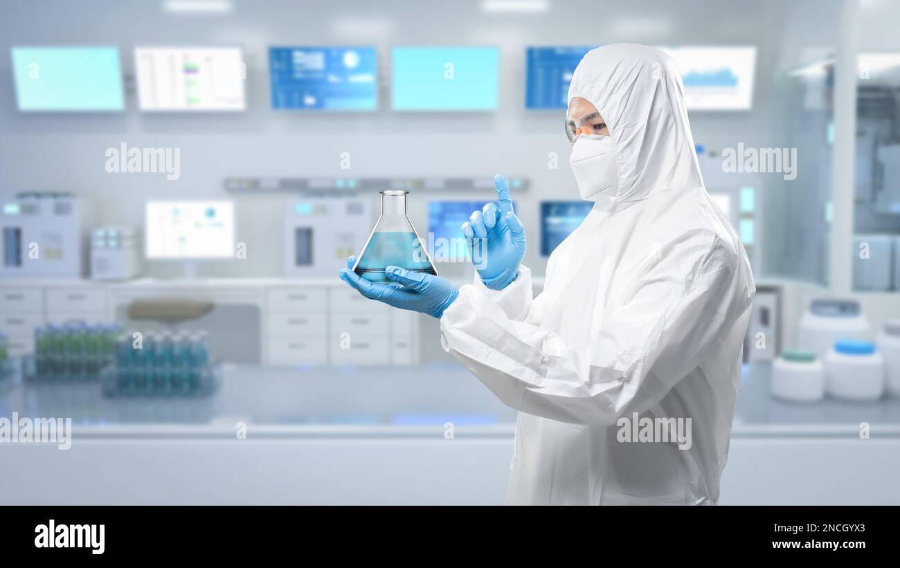 Worker wears medical protective suit or white coverall suit with flask ...