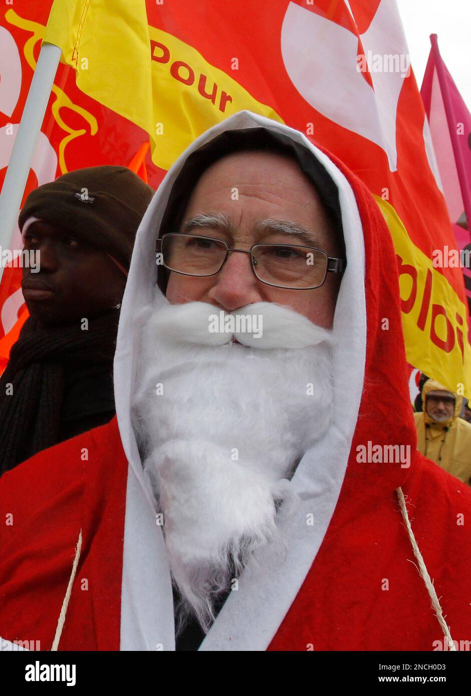 Demonstrators, some dressed in Santa Claus outfits, gather outside the ...