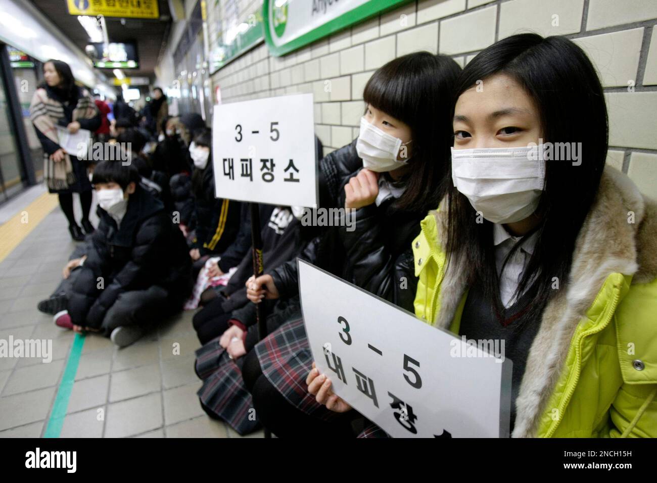 South Korean Ahyeon Middle School students take shelter from a ...