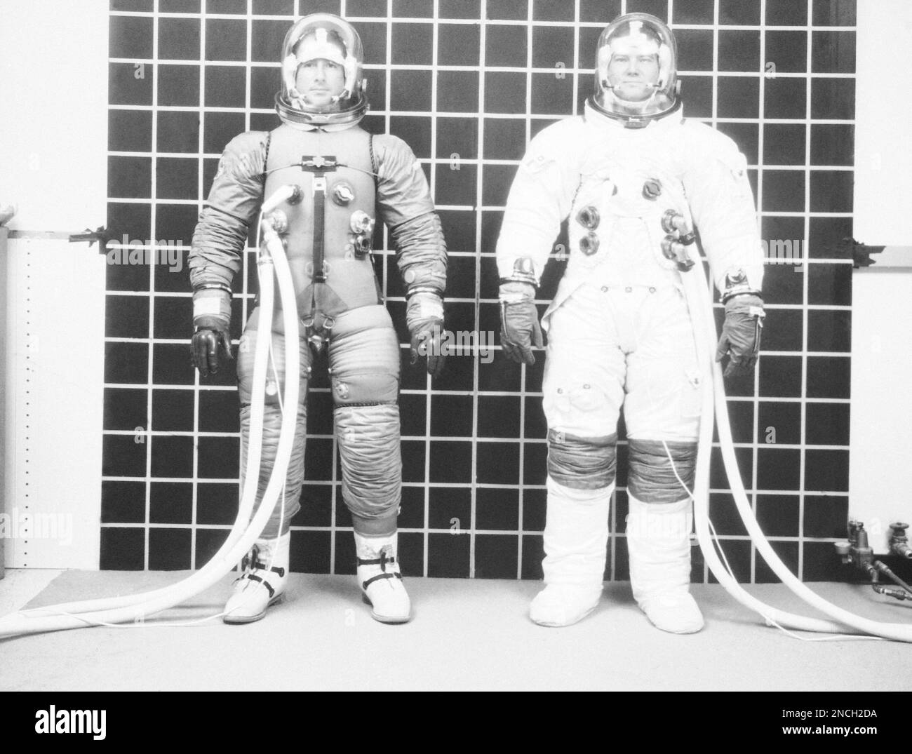 Astronaut John Bull, right, models the new Apollo pressure suit ...
