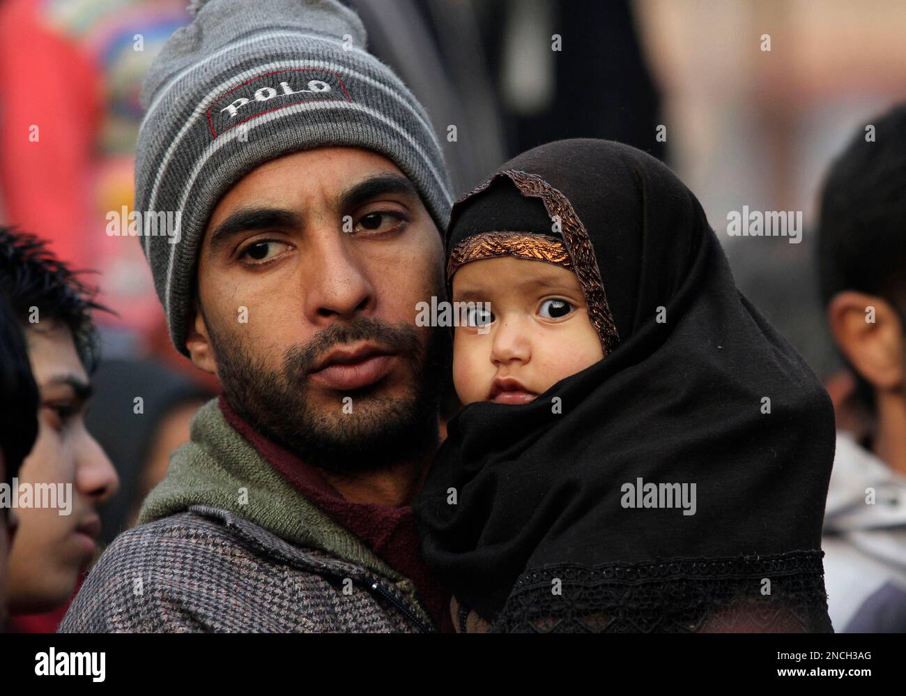 A Kashmiri man carries his daughter during a Muharram procession in ...