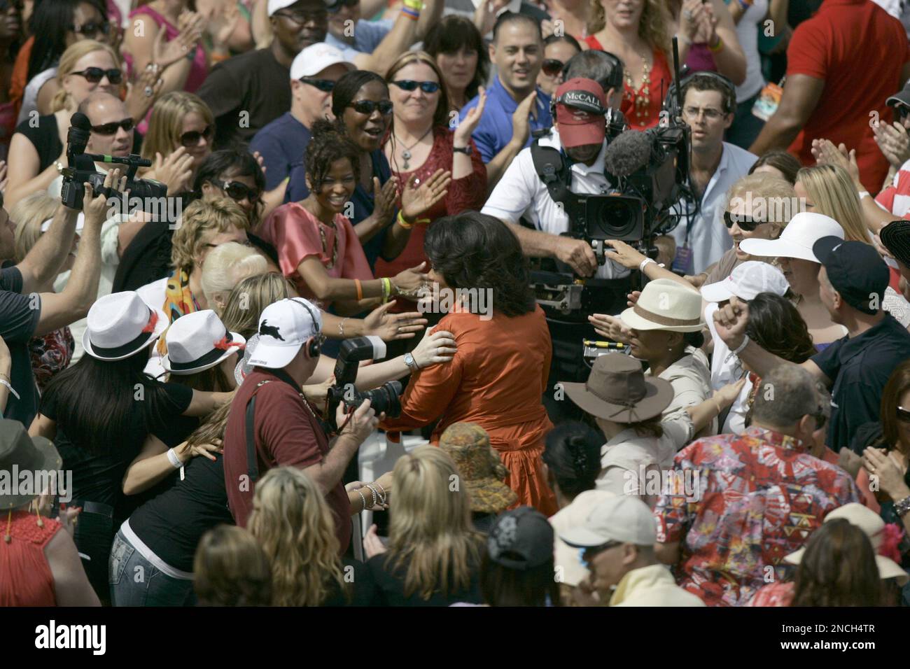 American talk show host Oprah Winfrey, center, is greeted by fans as ...
