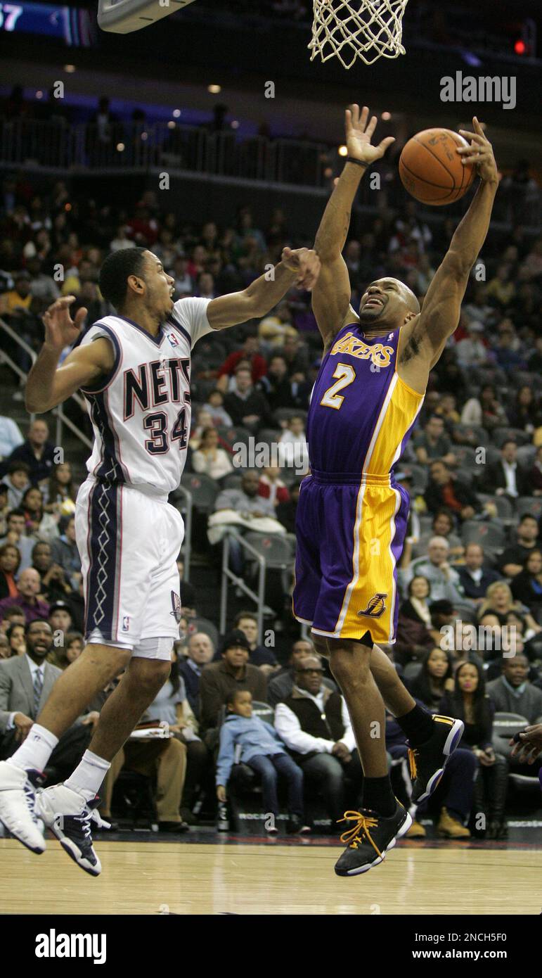 Los Angeles Lakers' Derek Fisher (2) grabs a rebound away from New ...