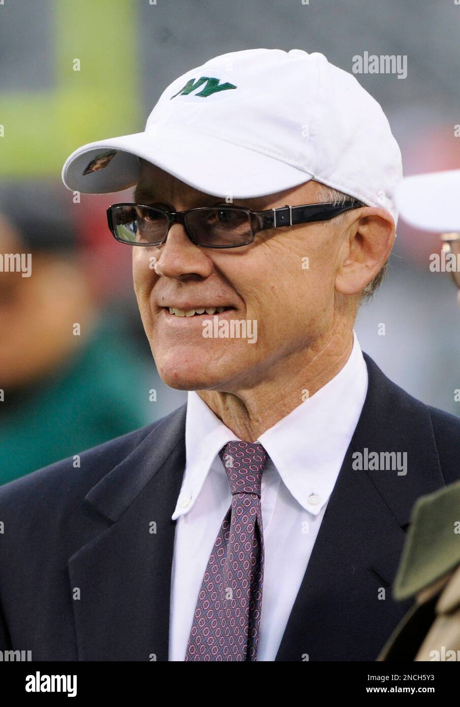 New York Jets owner Woody Johnson smiles before an NFL football game between the Miami Dolphins ...