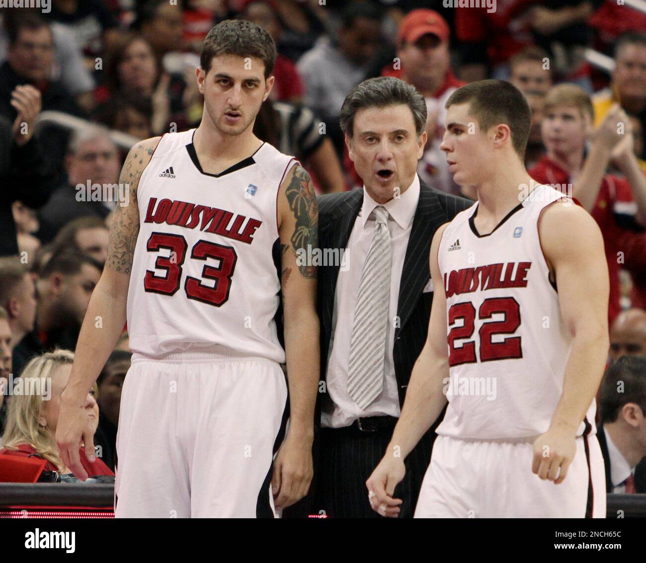 Louisville coach Rick Pitino walks substitutes Mike Marra (33) and ...