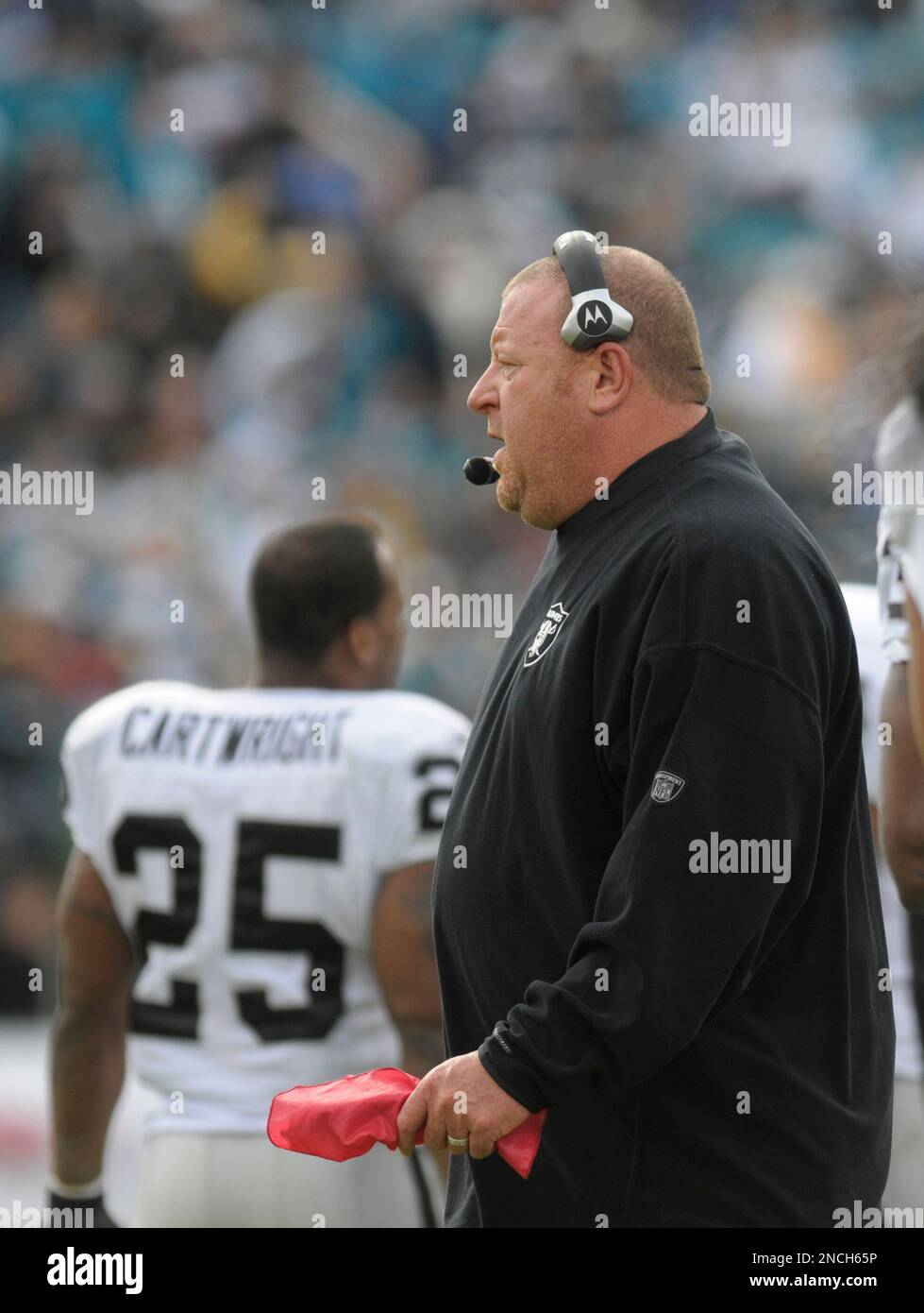 Oakland Raiders head coach Tom Cable, right, prepares to challenge a ...