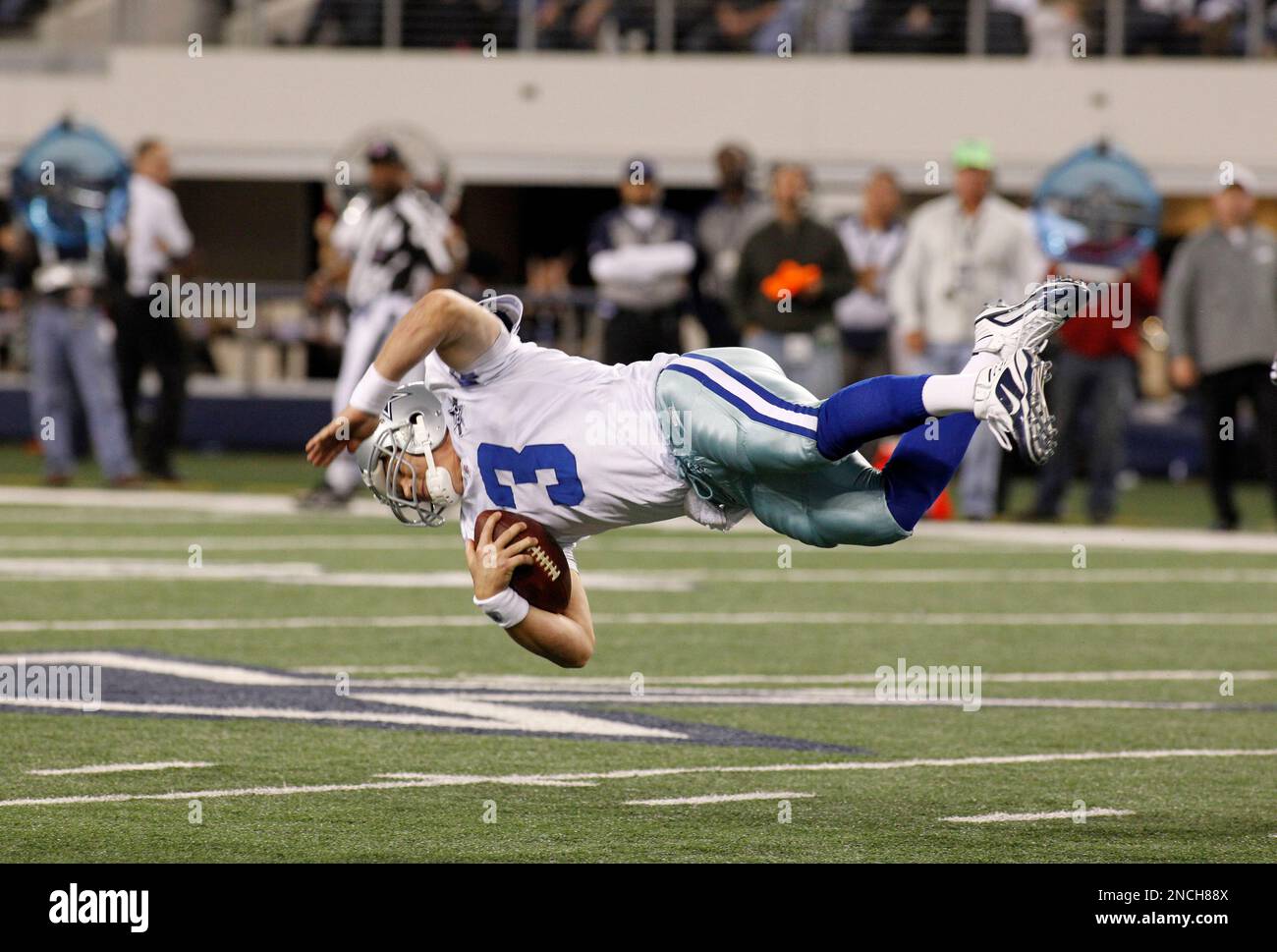 Dallas Cowboys quarterback Jon Kitna (3) ends up flying through the air ...