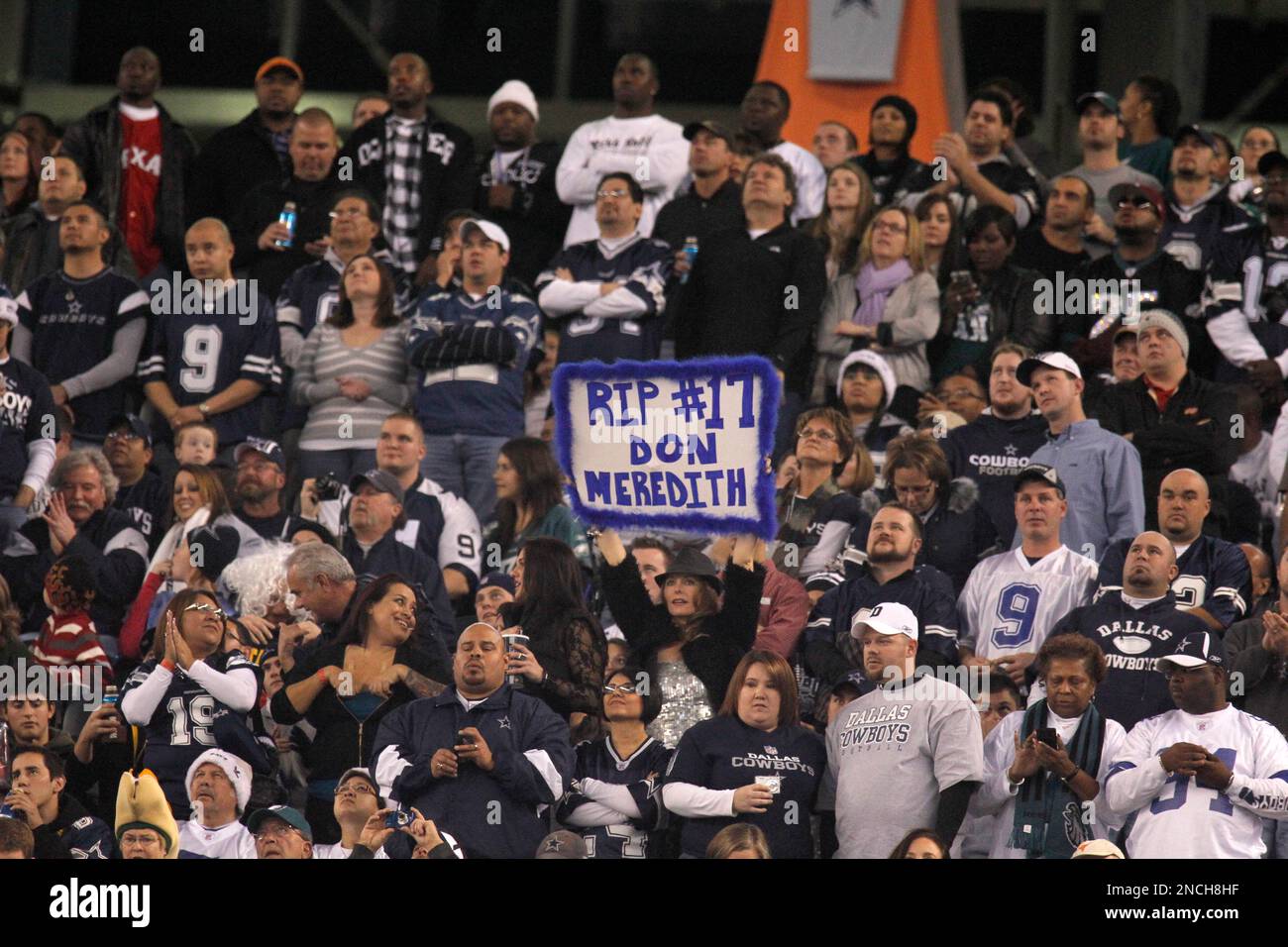 A Dallas Cowboys fan holds a tribute sign to former Cowboy quarterback ...
