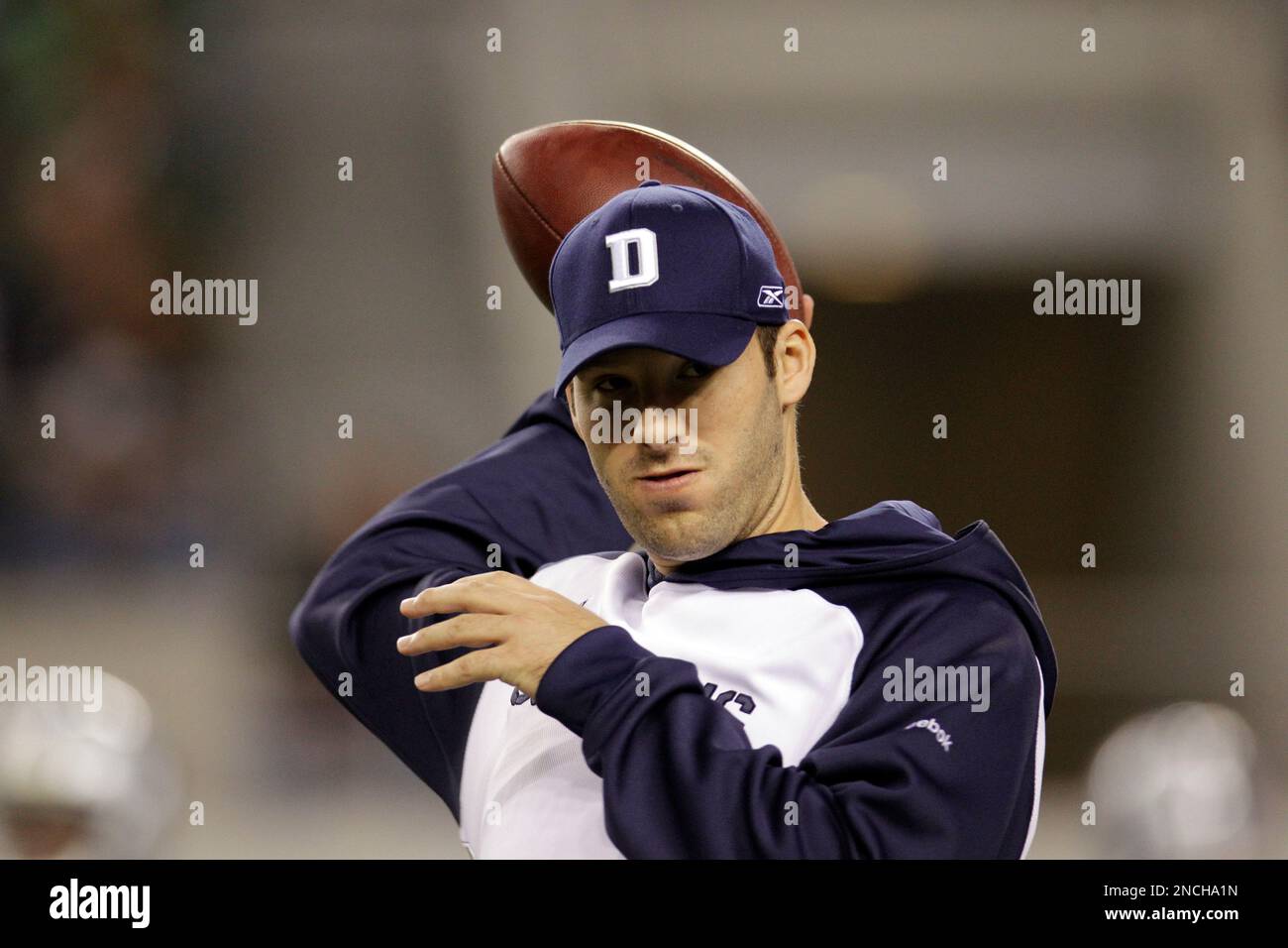 Injured Dallas Cowboys quarterback Tony Romo makes a pass on the field ...
