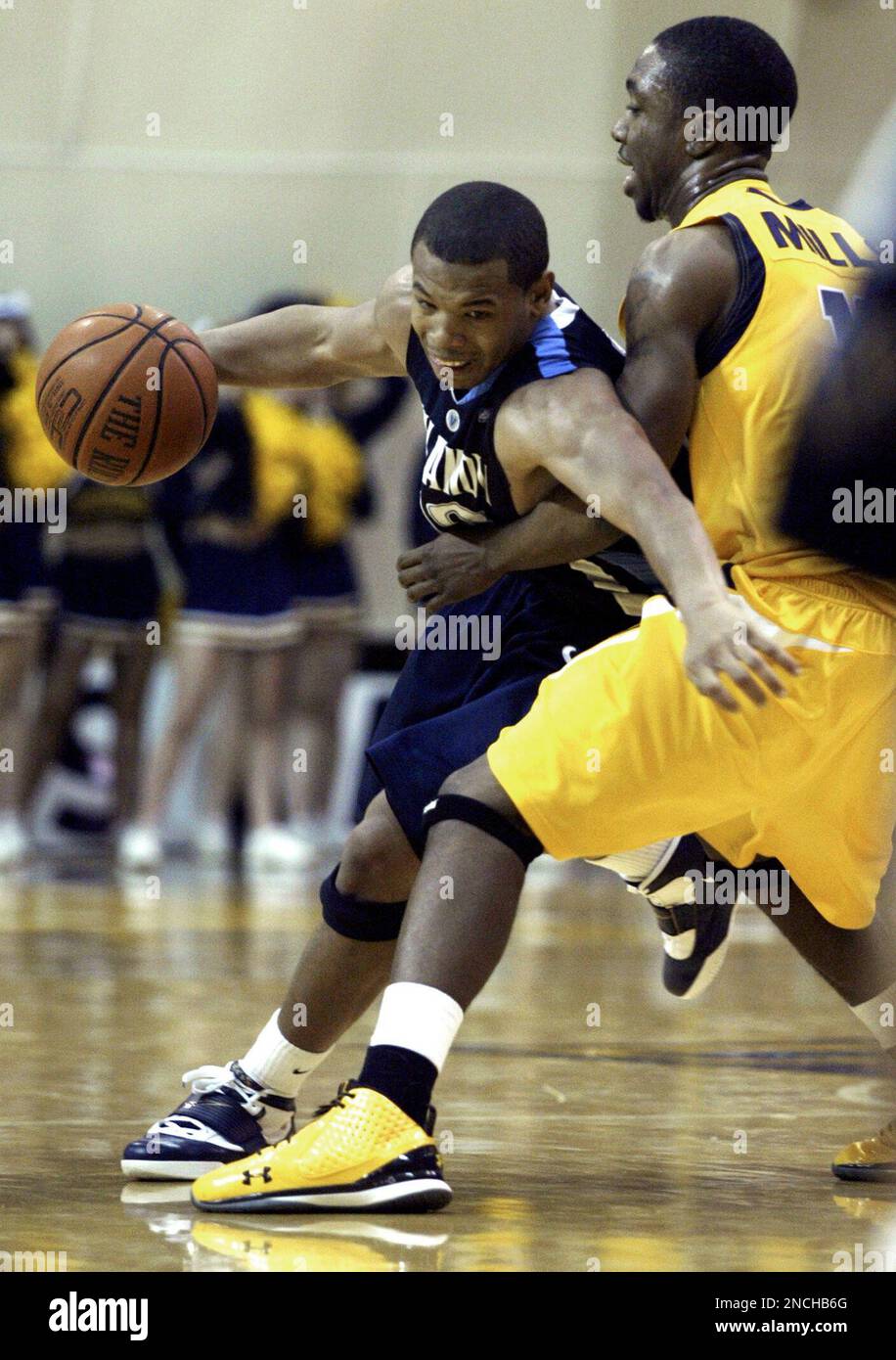 Villanova's Corey Fisher, left drives against La Salle's Sam Mills in ...