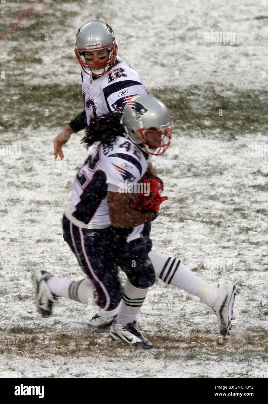 New England Patriots quarterback Tom Brady (12) hands off to running ...