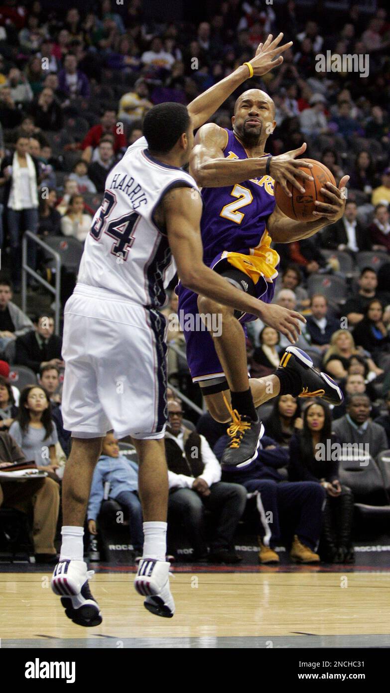 Los Angeles Lakers' Derek Fisher (2) attempts a layup past New Jersey ...