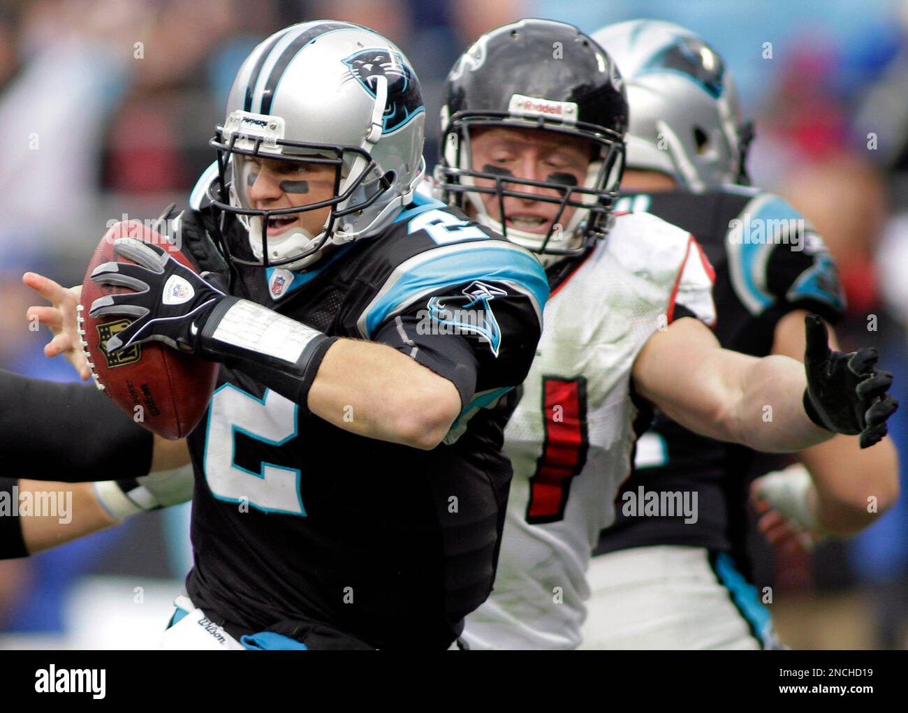 Carolina Panthers' Jimmy Clausen (2) is sacked by Atlanta Falcons' Kroy ...