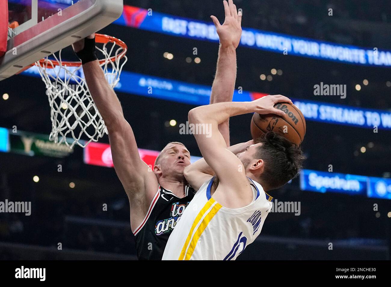 Golden State Warriors guard Ty Jerome, right, shoots as Los Angeles ...