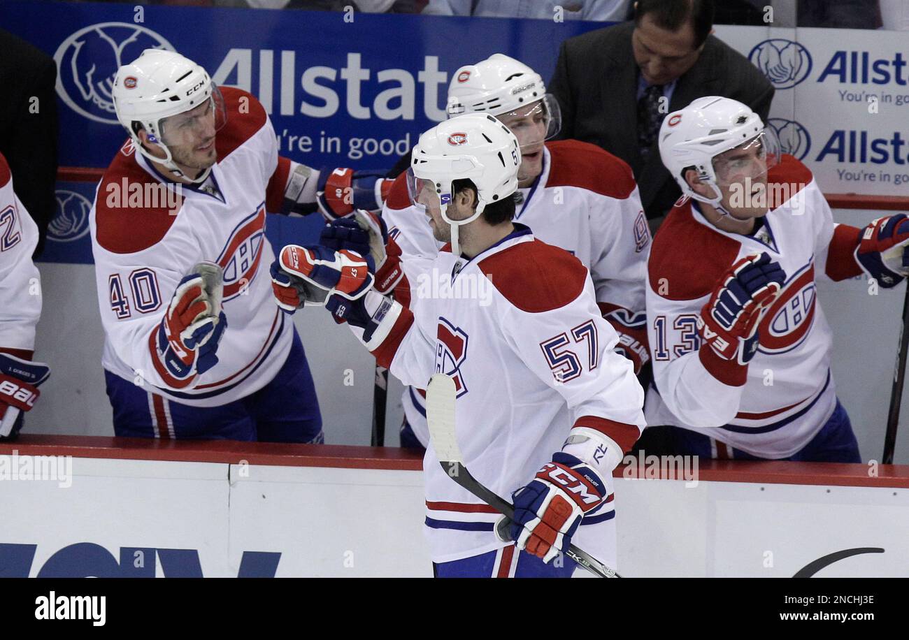 Montreal Canadiens left wing Benoit Pouliot, rear, is congratulated by ...