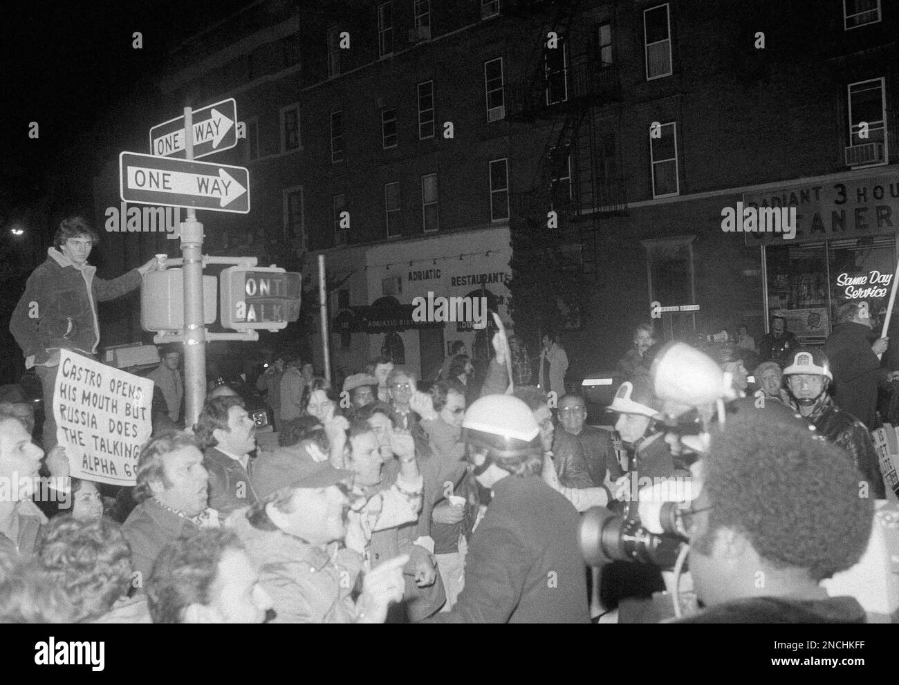 Police barricades hold back a crowd of yelling anti-Castro ...