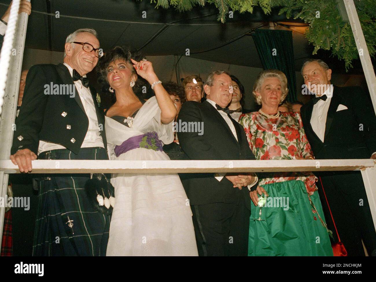 Publisher Malcolm Forbes, left, talks with Elizabeth Taylor at 70th birthday bash for Forbes ...