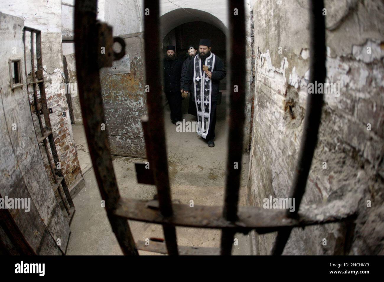 Orthodox priests walk in Fort 13 of the Jilava jail in Jilava, Romania ...