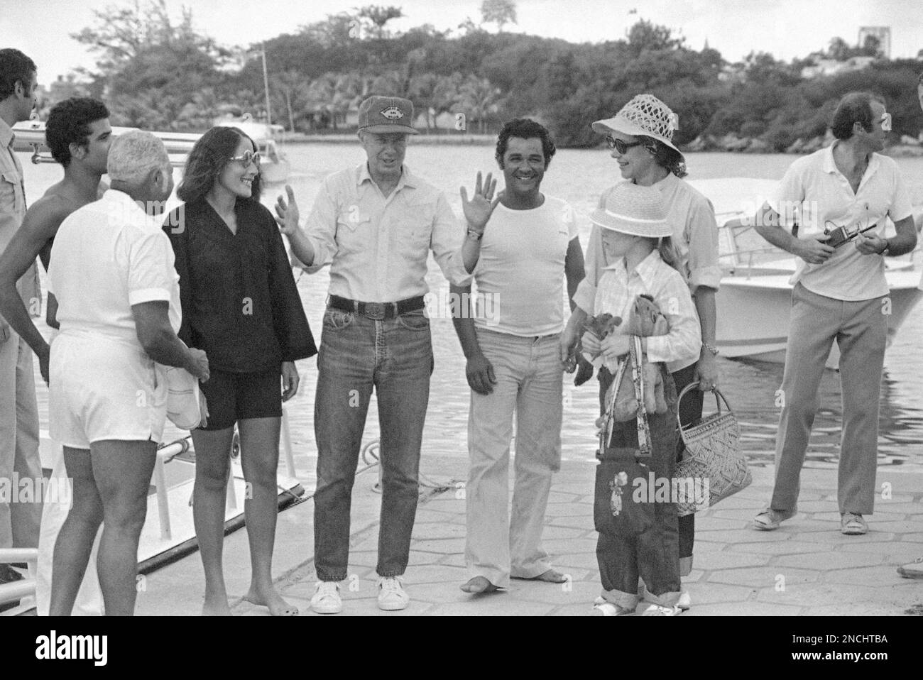 President Jimmy Carter illustrates the size of the fish he caught on a ...