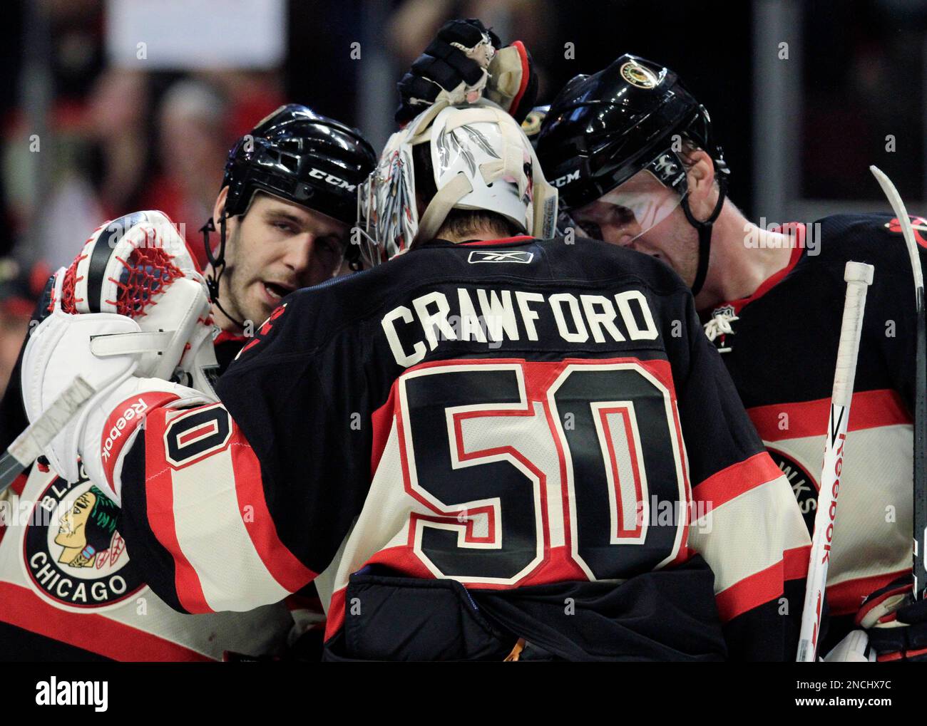 Chicago Blackhawks' goalie Corey Crawford (50) celebrates with Jake ...