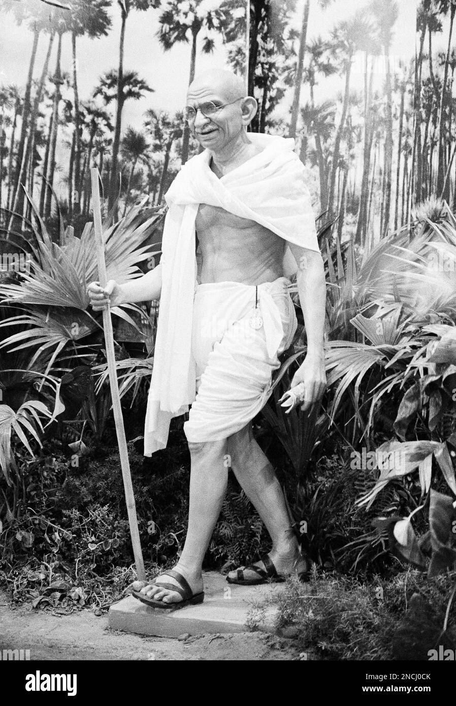 A realistic wax figure of Mohandas Gandhi depicting one of his famous ...