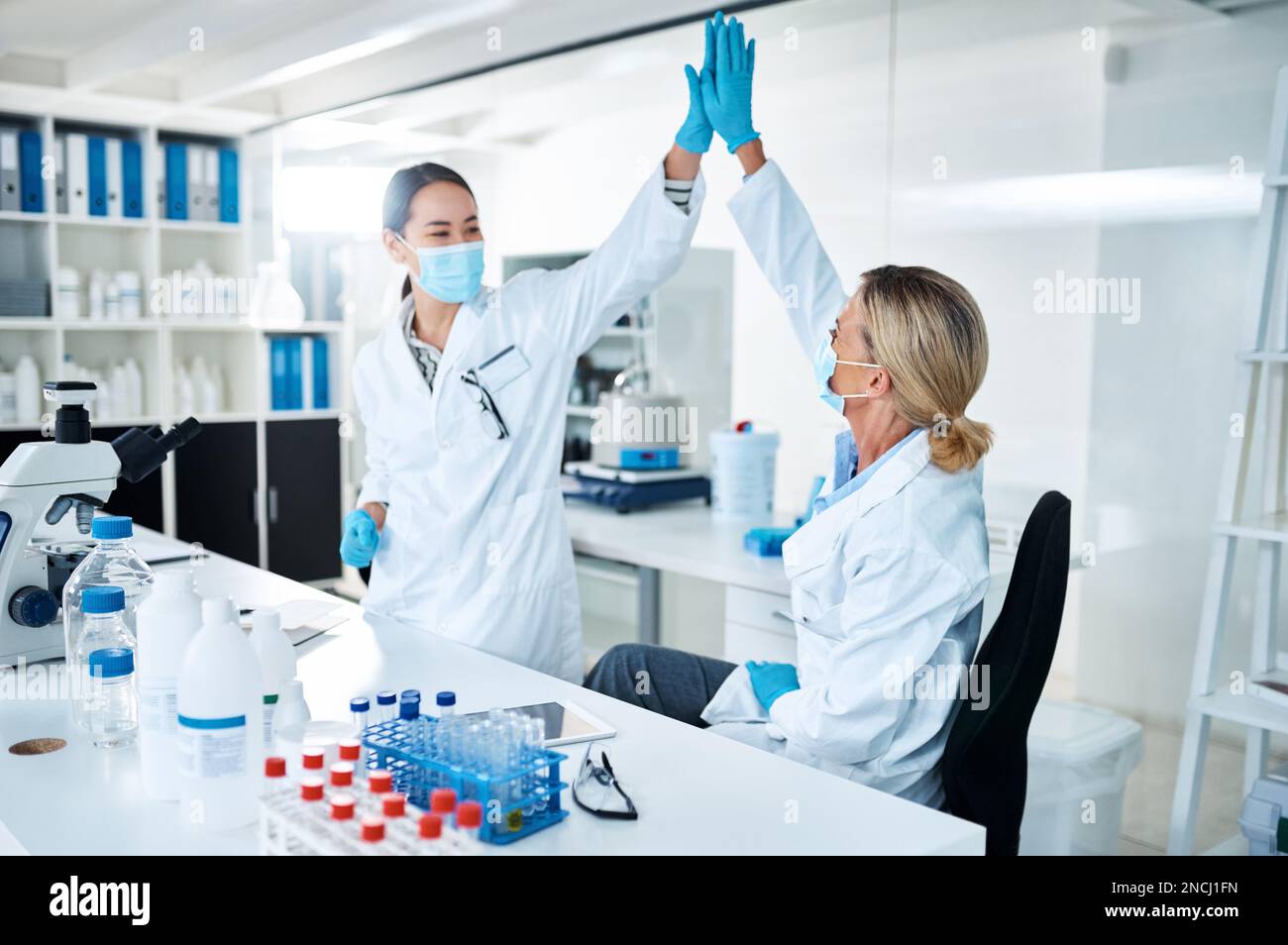 Science makes positive and remarkable progress in the world. two scientists giving each other a ...