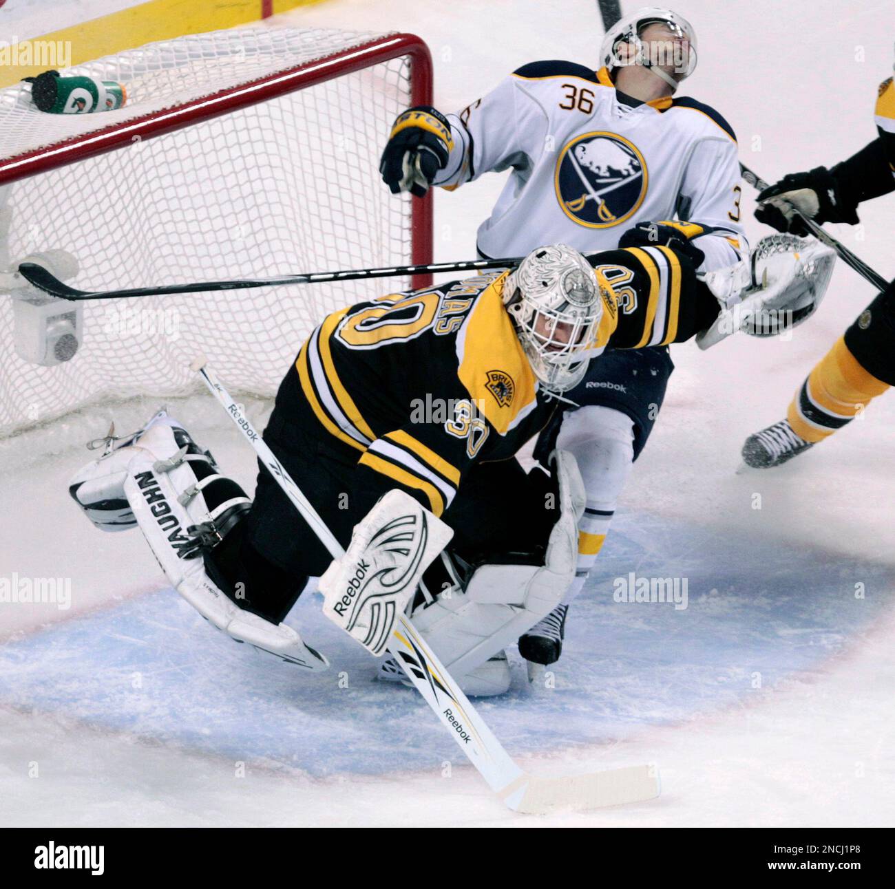 Boston Bruins goalie Tim Thomas, left, checks Buffalo Sabres right wing ...