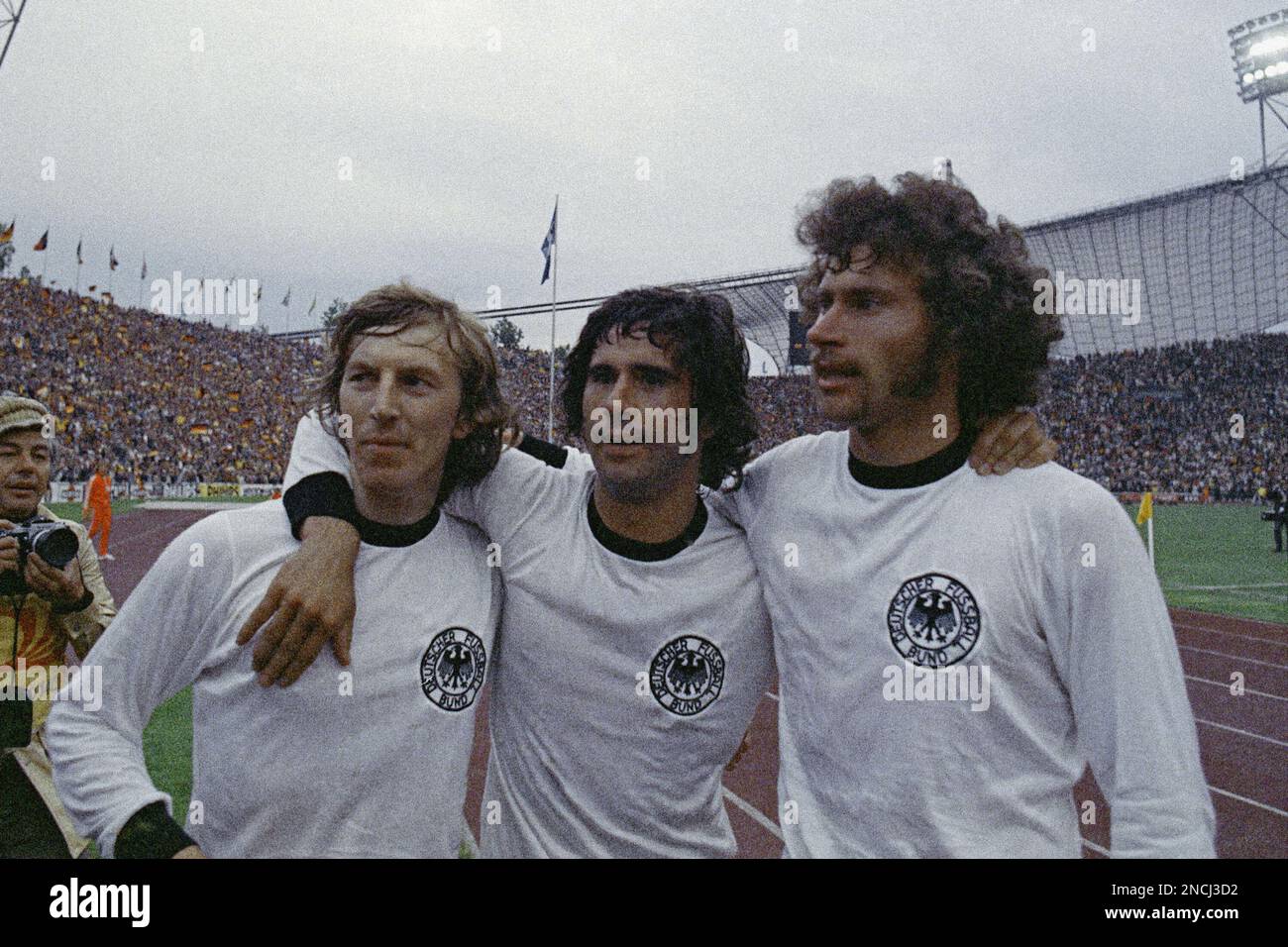 West German national soccer team forward Gerd Mueller, center, embraces ...