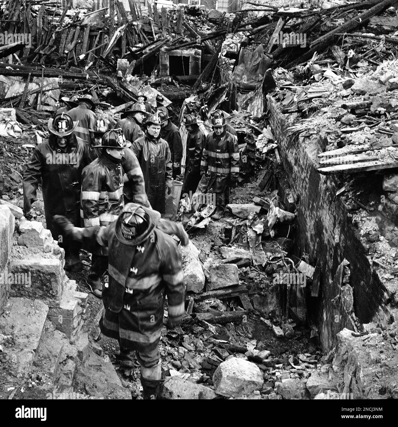 Firemen probe wreckage at Scene, Dec. 17, 1960 where jet airliner ...