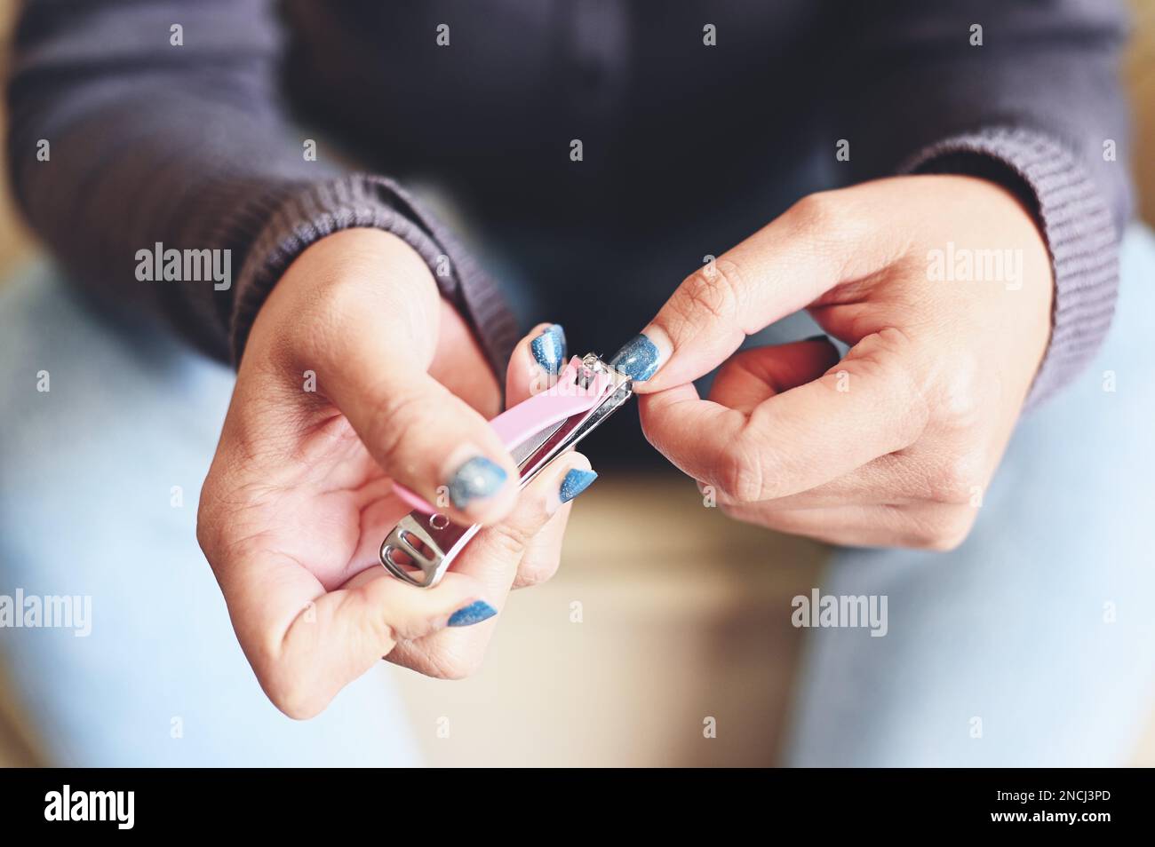cut nails concept, woman hand holding nail clipper and cutting nails ...