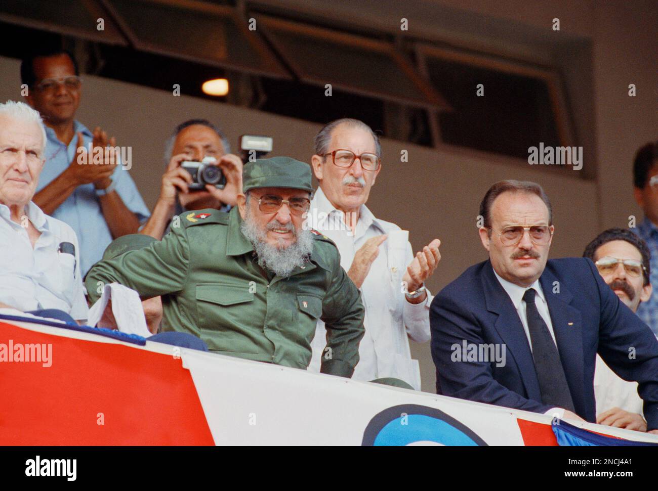 Cuban leader Fidel Castro rises from his chair and grimaces as he ...