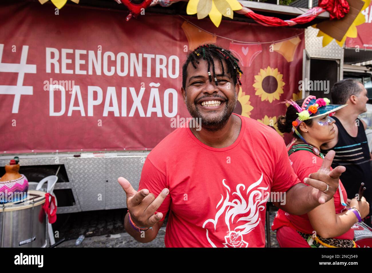 A Monobloco band member poses for a photo in front of the hashtag ...