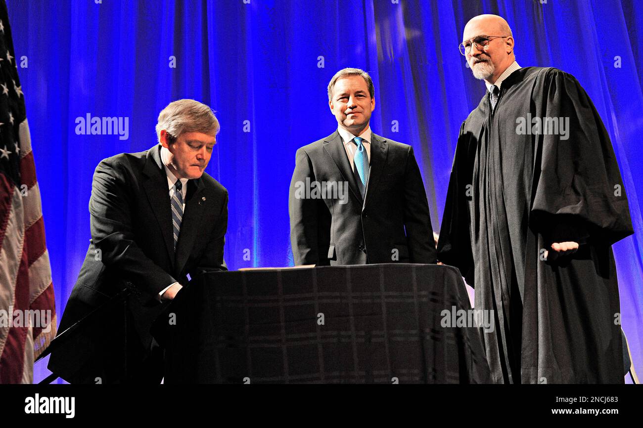 Alaska's newly elected Lt. Gov. Mead Treadwell, left, signs his oath of ...
