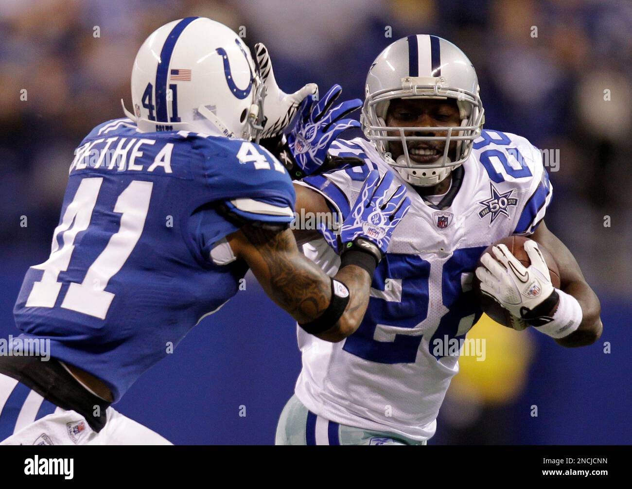 Dallas Cowboys running back Felix Jones, right, pushes off Indianapolis ...