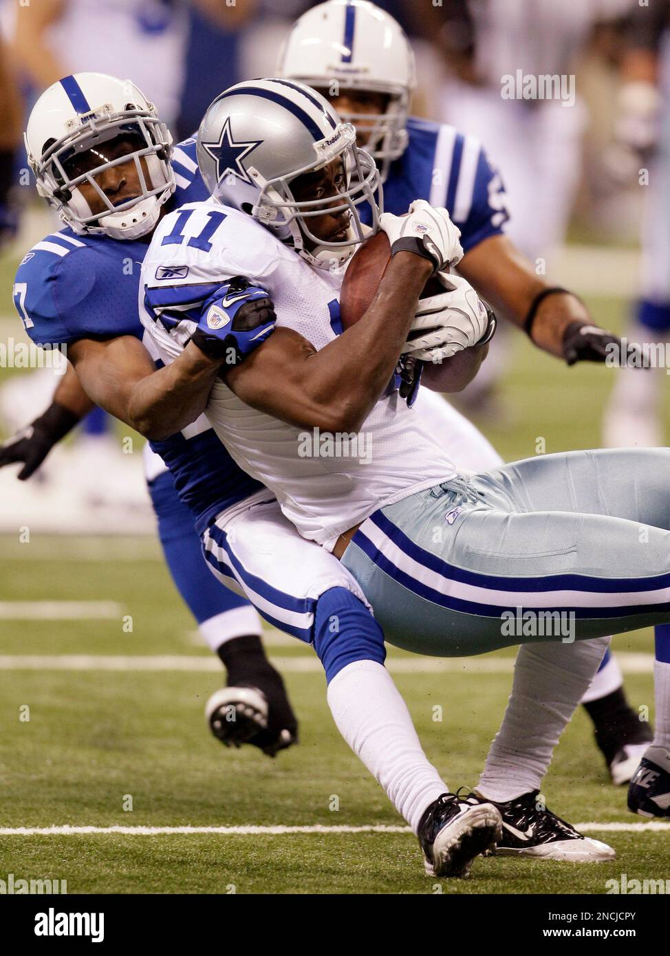 Dallas Cowboys wide receiver Roy E. Williams, right, is tackled by ...