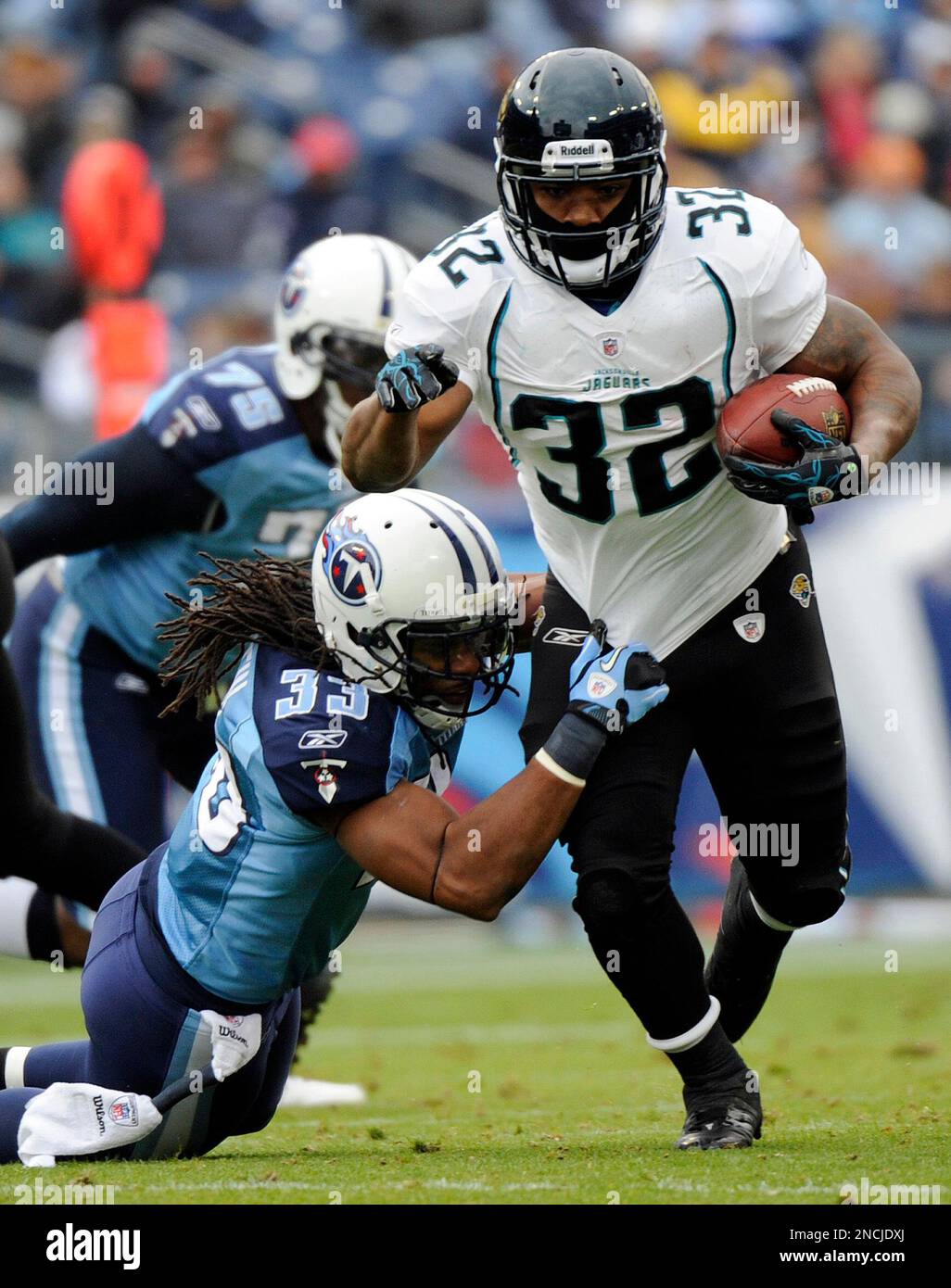 Tennessee Titans safety Michael Griffin (33) tries to drag down ...