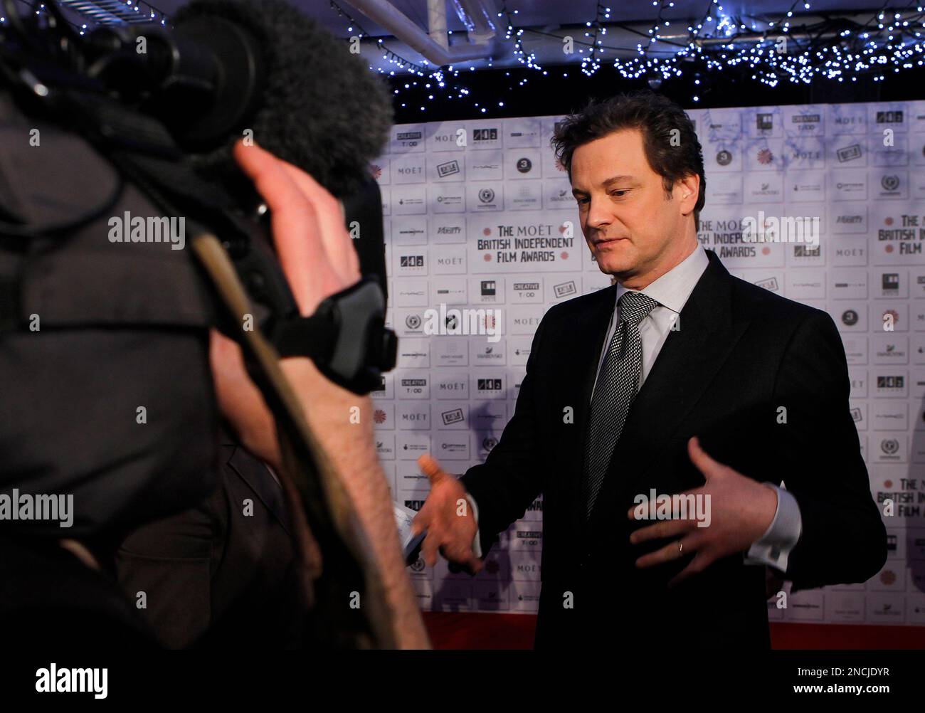 British actor Colin Firth talks to media as he arrives for the British ...