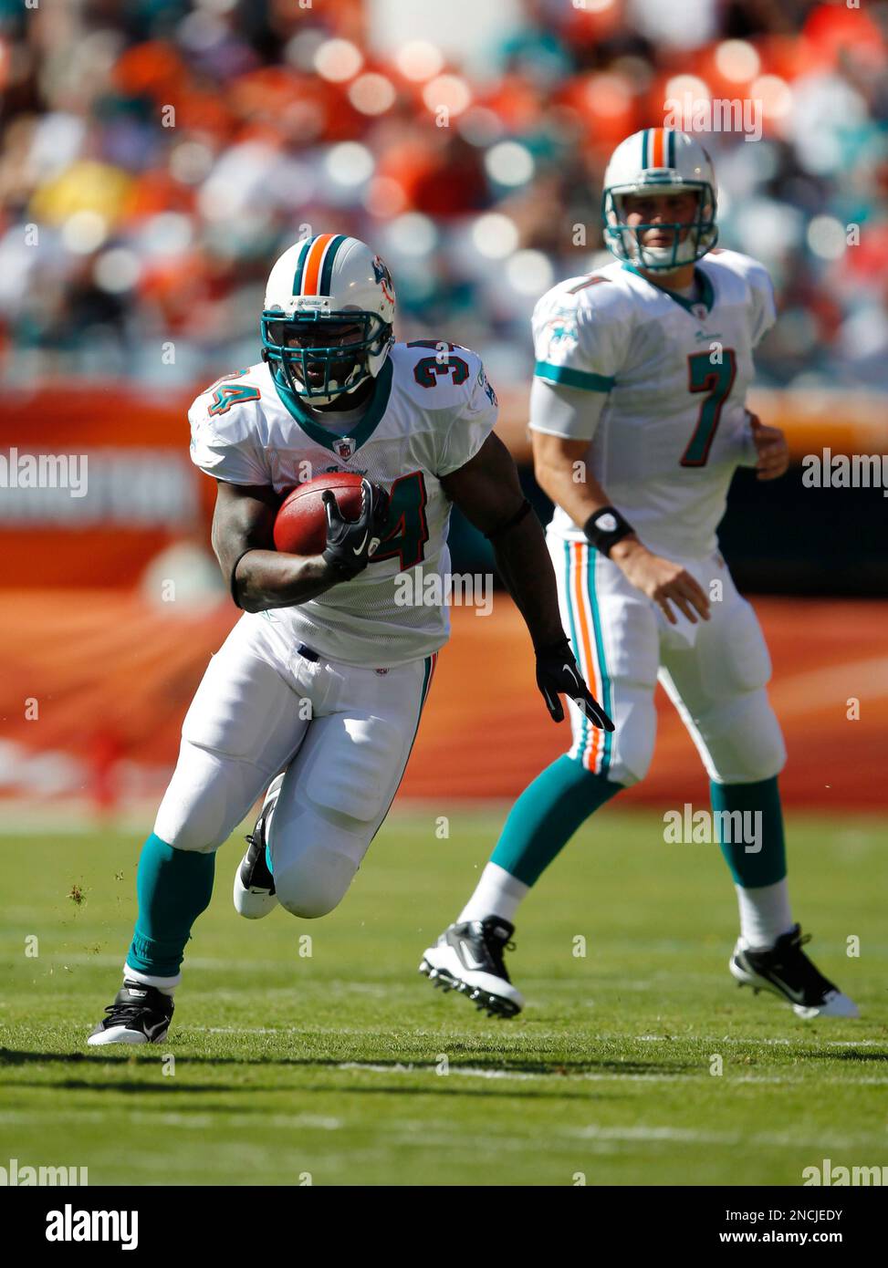 Miami Dolphins running back Ricky Williams (34) runs as quarterback ...