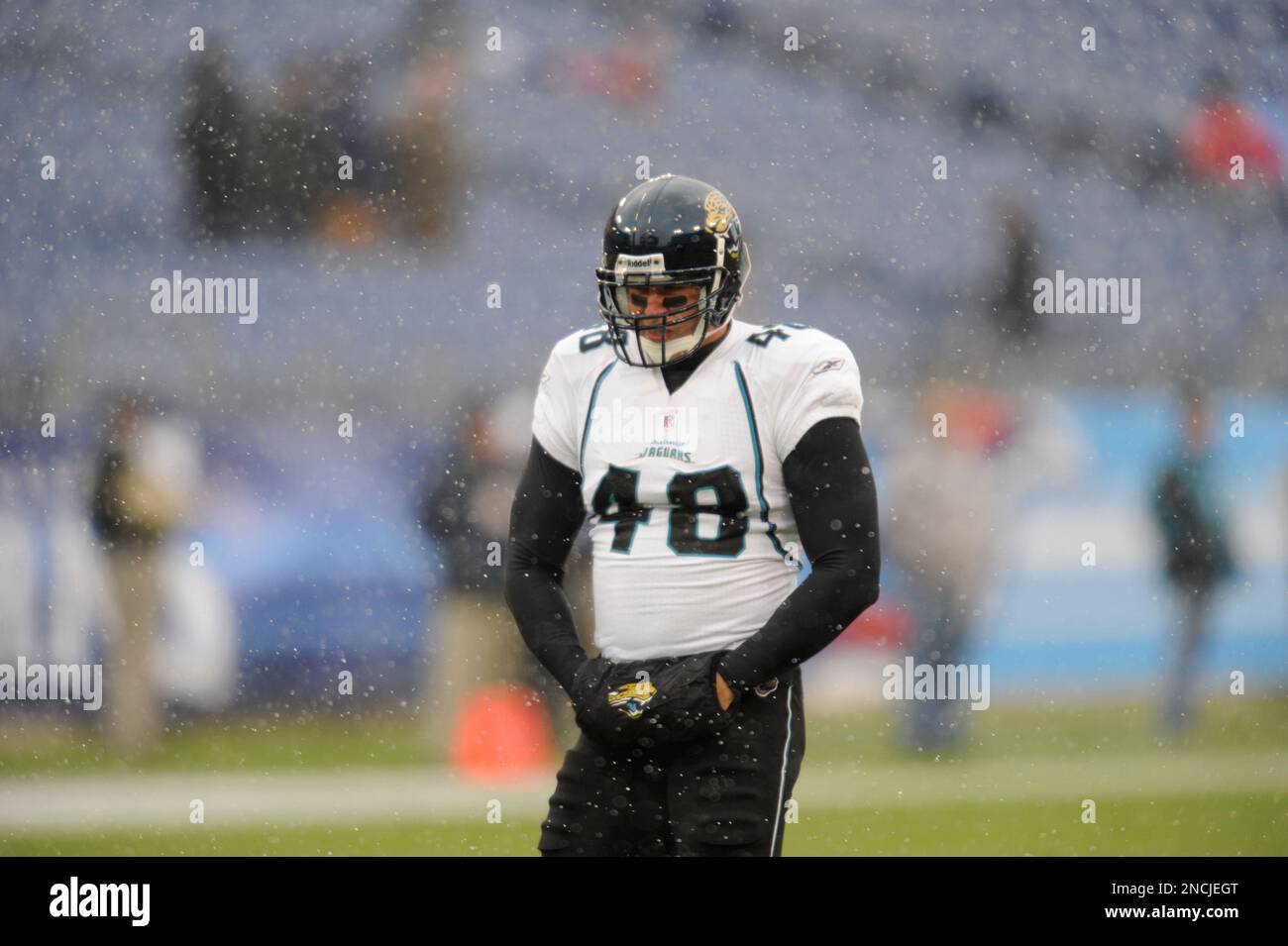 Jacksonville Jaguars player Jeremy Cain warms up in the snow before the ...