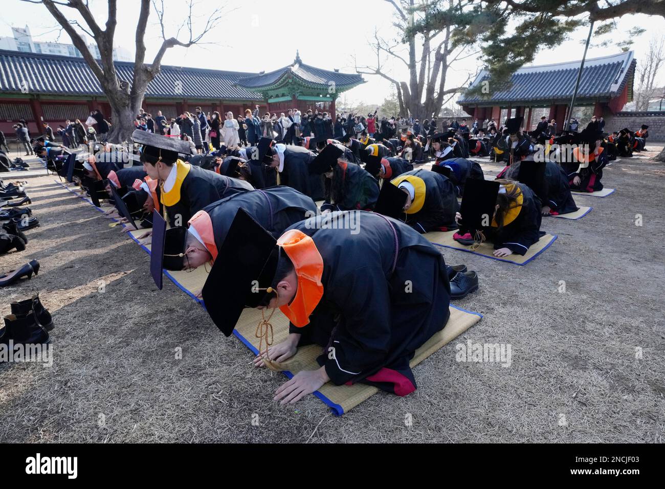 Graduates bow as they pay homage to great sages during their graduation ...