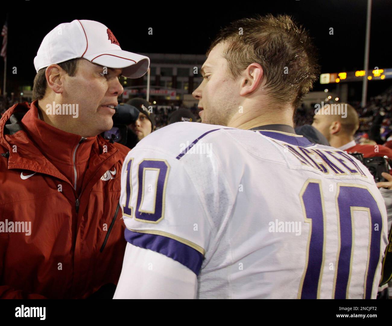 Washington State head coach Paul Wulff talks to Washington quarterback ...