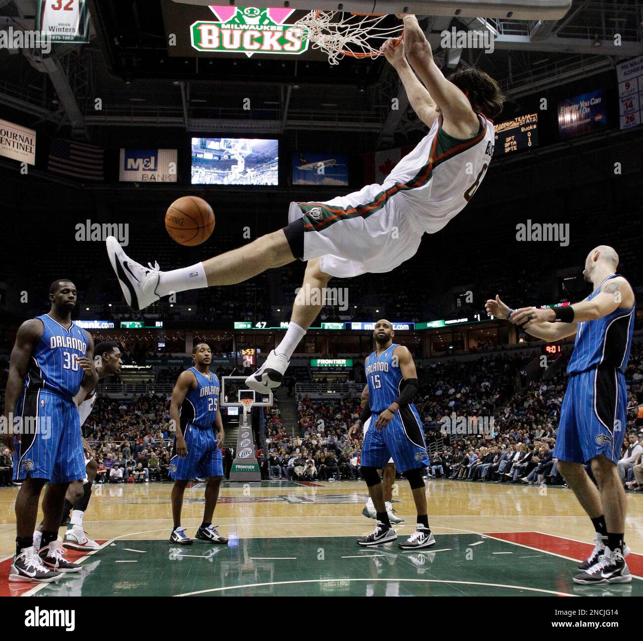 Milwaukee Bucks' Andrew Bogut dunks in front of Orlando Magic's Brandon ...