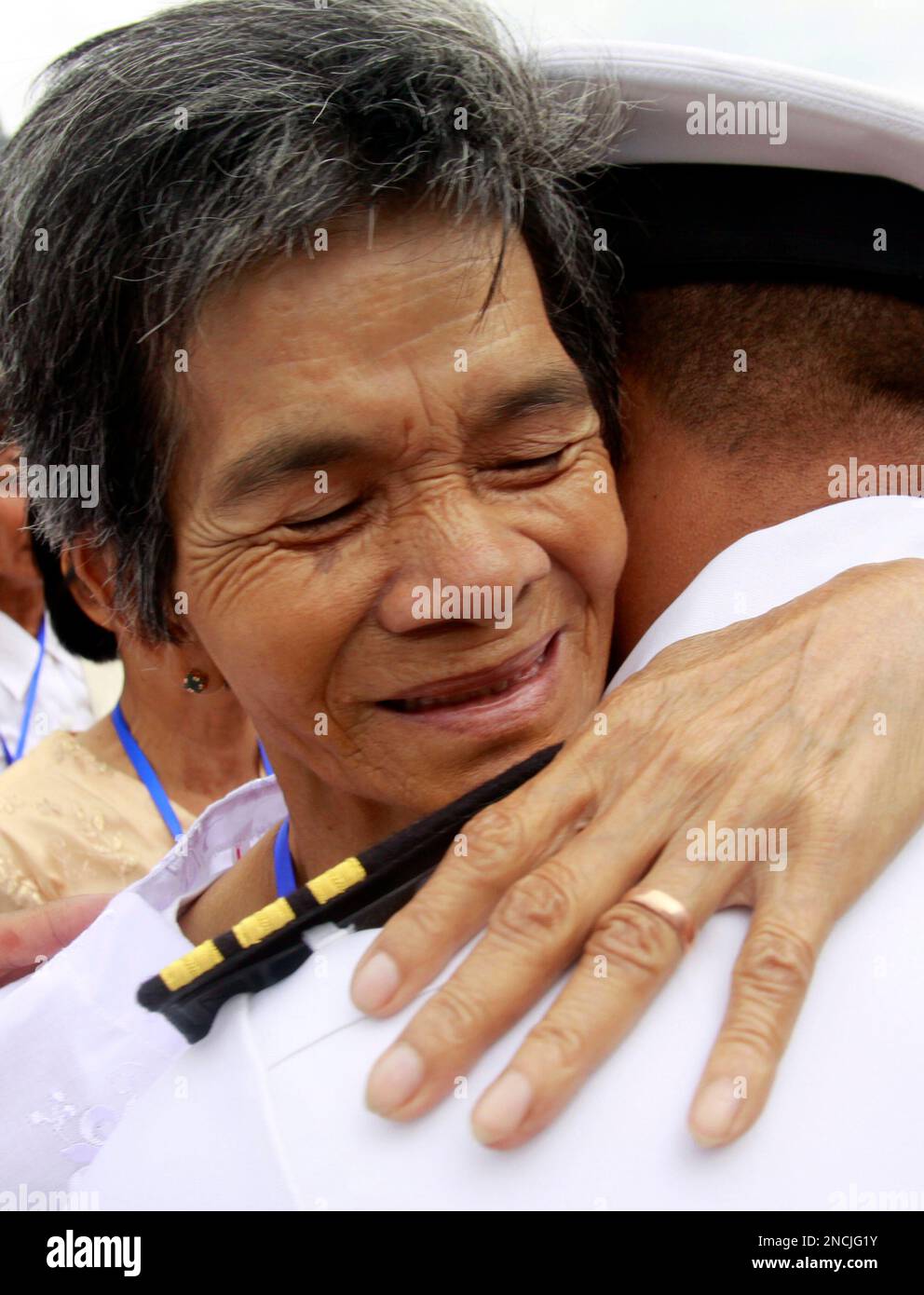 In this photo taken Dec. 3, 2010, Samrith Sokha, 72, hugs her nephew and U.S. navy officer ...
