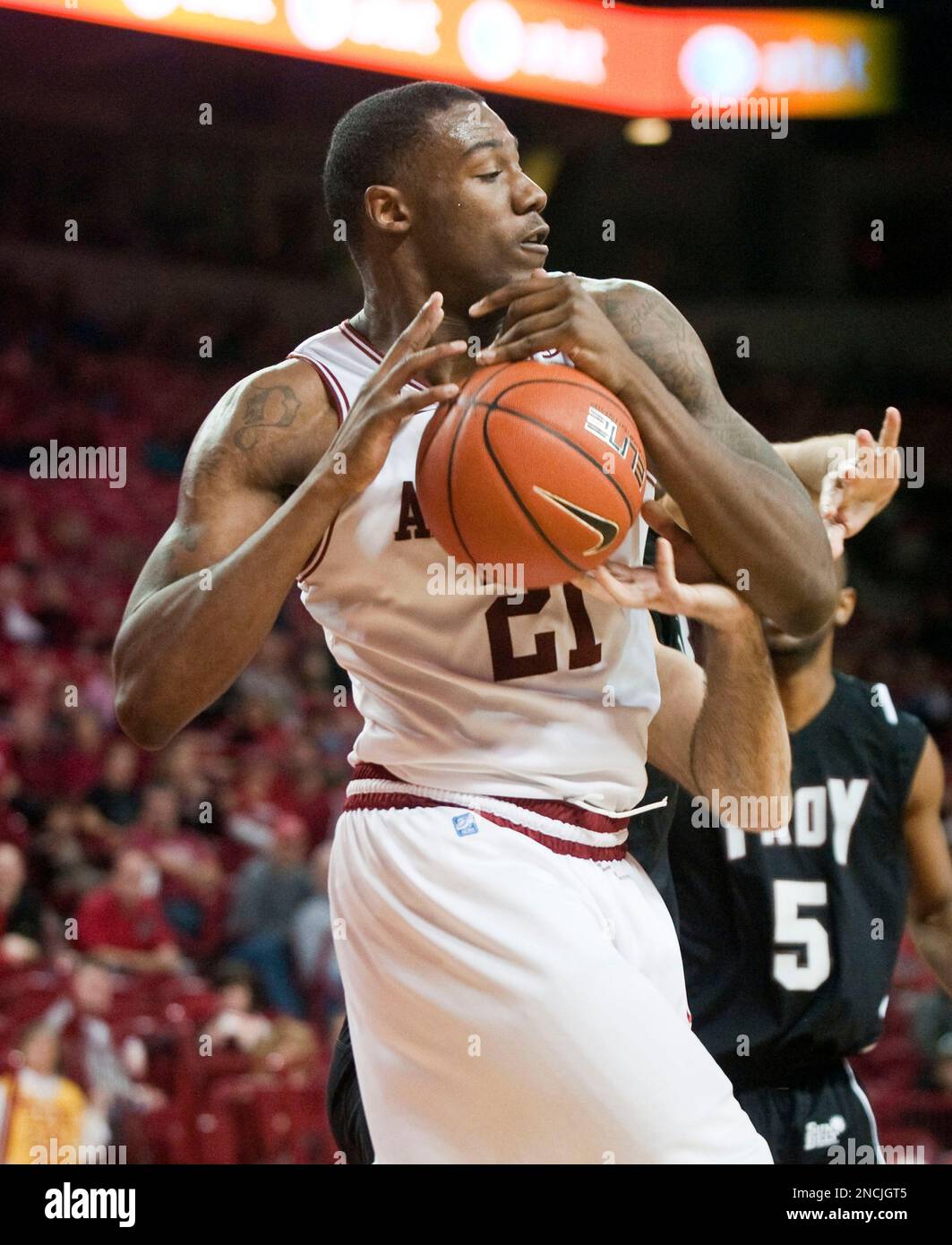 Arkansas forward Delvon Johnson (21) has the ball knocked loose by Troy ...