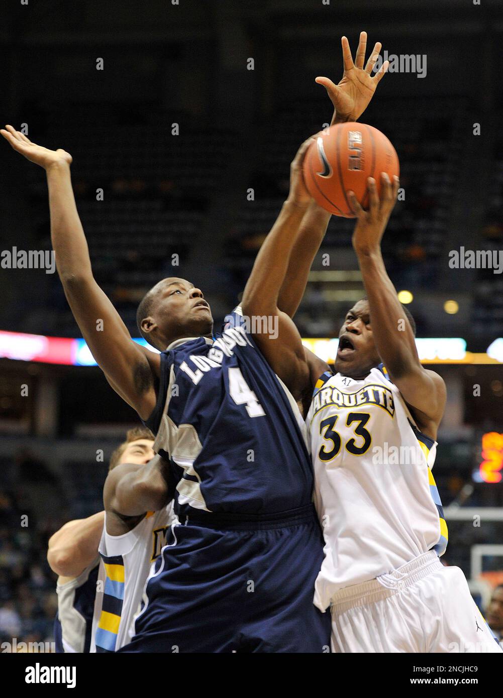 Longwood's Antwan Carter (4) defends as Marquette's Jimmy Butler (33 ...