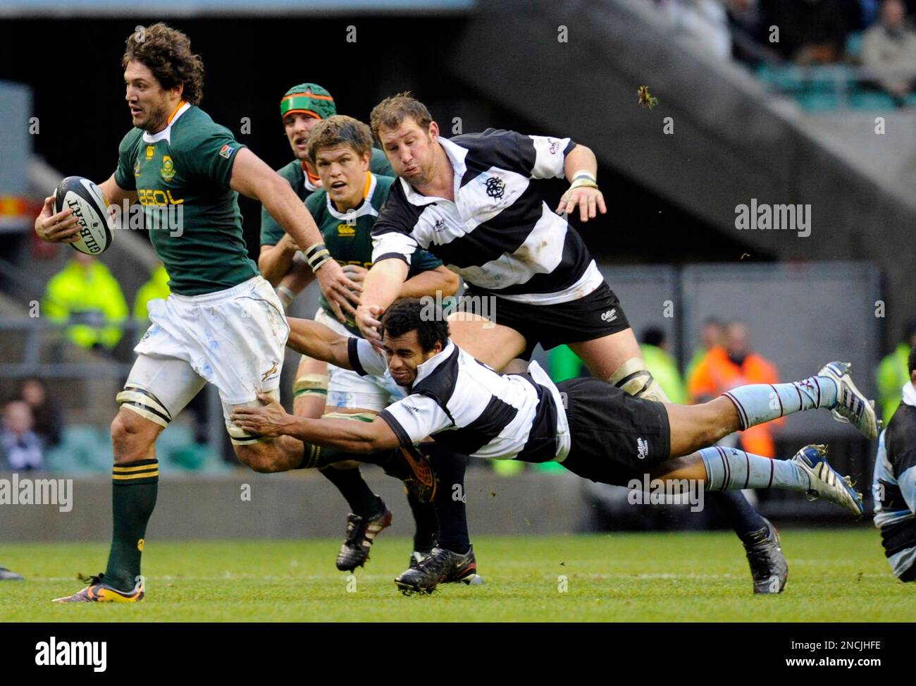 South Africa's Ryan Kankowski, left, breaks past the tackle from ...