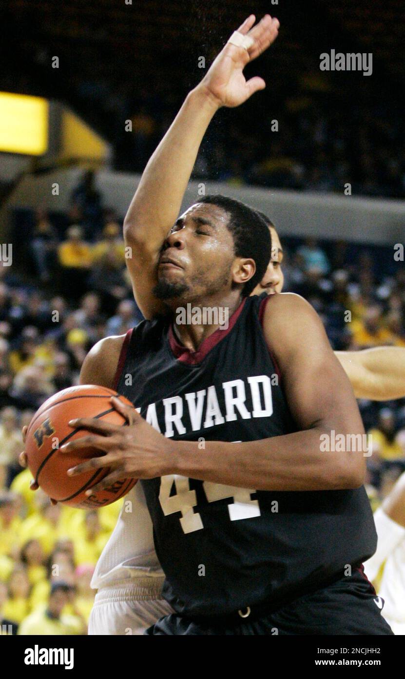 Harvard forward Keith Wright, front, gets an arm in the face from ...