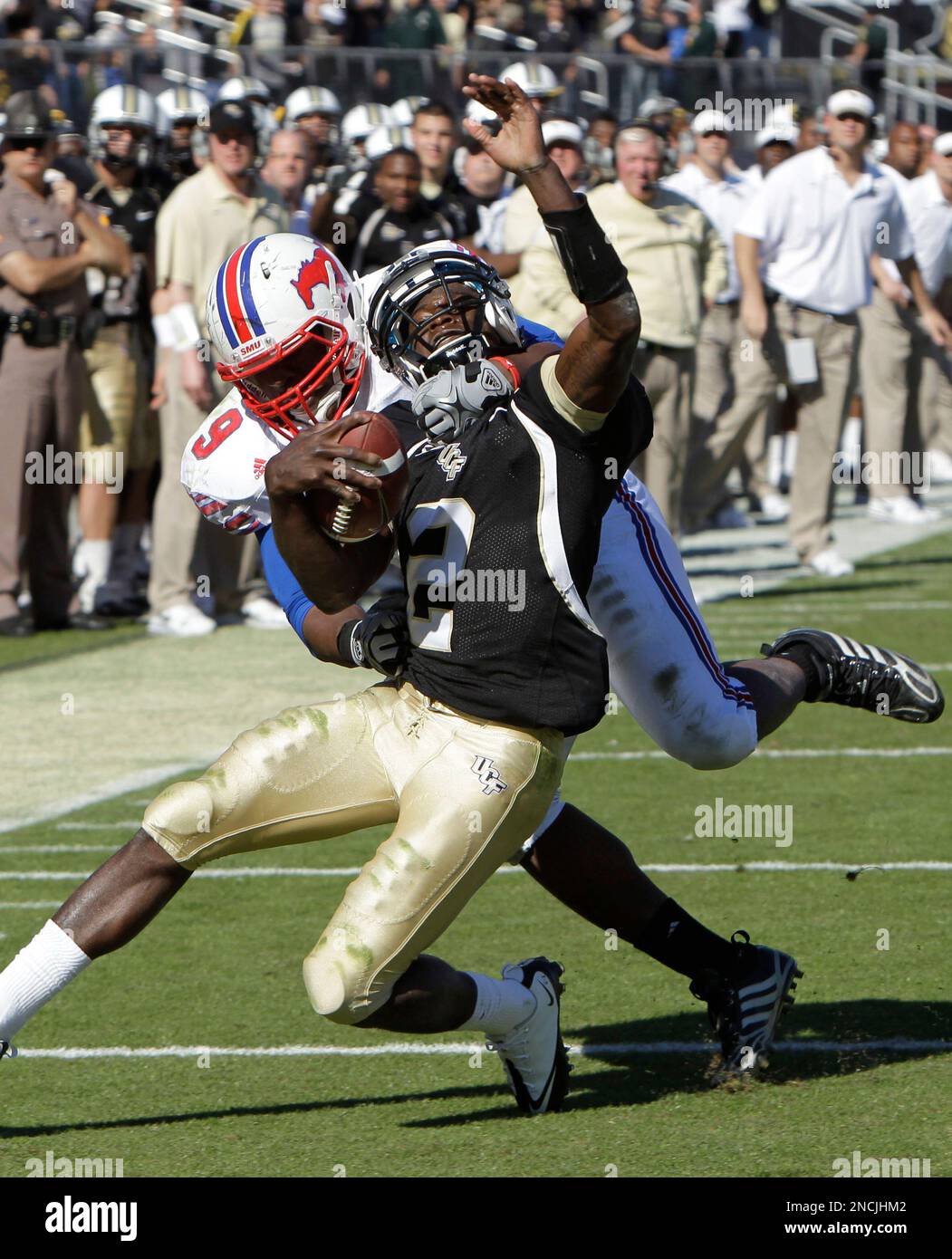 Central Florida quarterback Jeffrey Godfrey (2) is tackled by SMU's ...