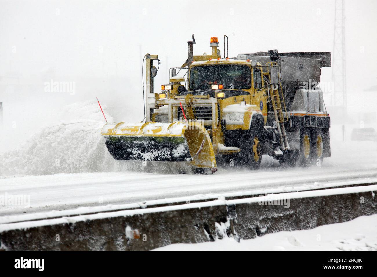 A plow truck driver plows snow on the New York State Thruway during a ...